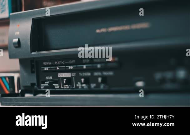 Insert VHS cassette into VCR player. Black vintage videotape cassette ...