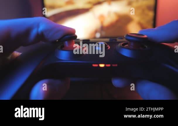 Joystick. Hands of a player, a teenage gamer playing a video game, on ...