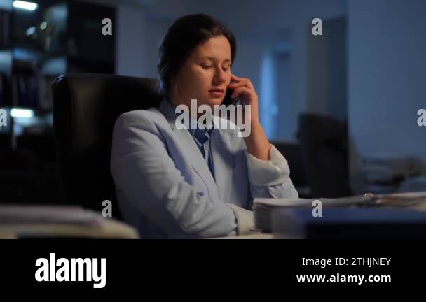 Angry dissatisfied woman talking on phone hanging up hitting table with ...