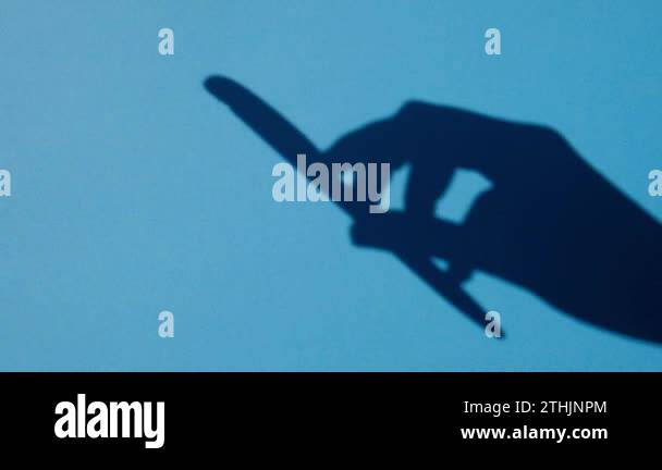 shadow hand twists the handle on a blue background, free space. Sign ...
