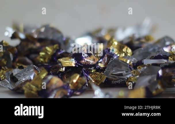 Mumbai, India, March, 2023: Candy wrappers falling in slow motion ...