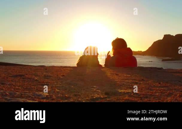 Two people talking at sunset at the beach Stock Video Footage - Alamy
