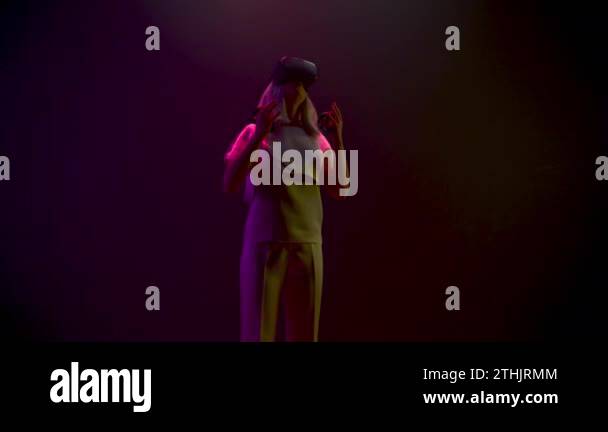 Young woman touching playing virtual world game. Amazed gamer wearing ...