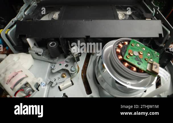 The head of an old VHS VCR with a VHS cassette and the operation of the ...