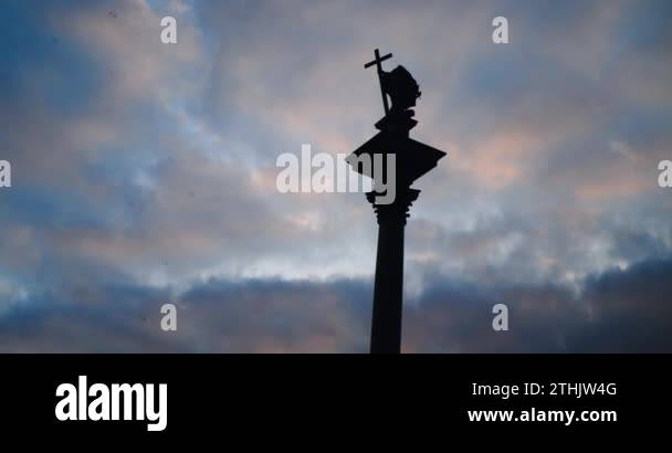An ominous dark monument. Silhouette of a statue of a man with a cross ...