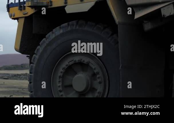 A huge dump truck transports ore and soil. The close-up shot from the ...
