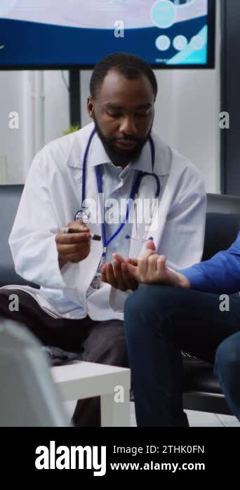 Vertical video: Specialist doing medical test with diabetic man in ...
