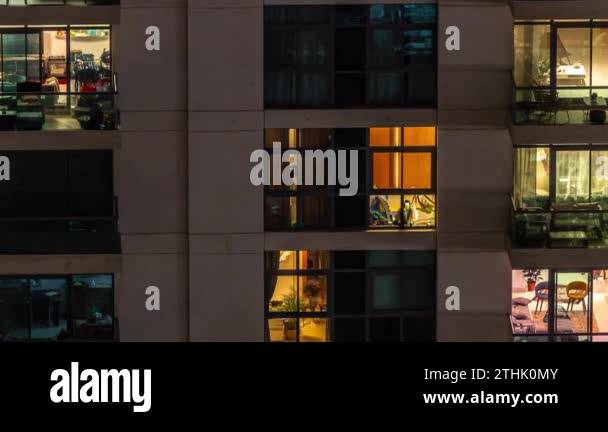 Windows of apartment building at night timelapse, the light from ...