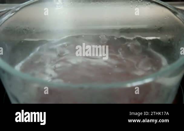 Water boiling in glass bowl Stock Video Footage - Alamy