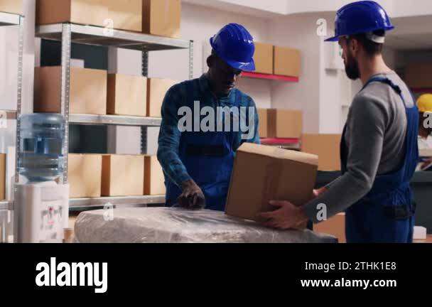 Team of diverse men using scanner and tablet for logistics and ...