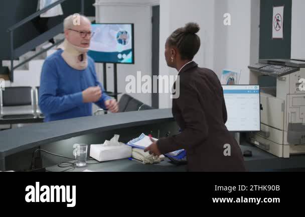 Medical worker helping injured patient with cervical collar at hospital ...