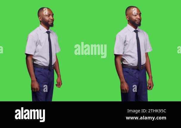Young businessman posing on greenscreen background, wearing office suit ...