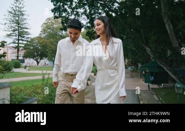 Romantic couple walking stairs outdoors. Handsome brunette gentleman ...