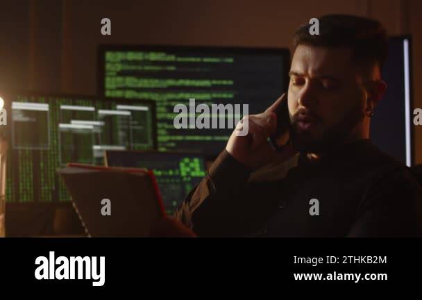 Hacker tells his requirements on the phone. Programmer talking on the ...