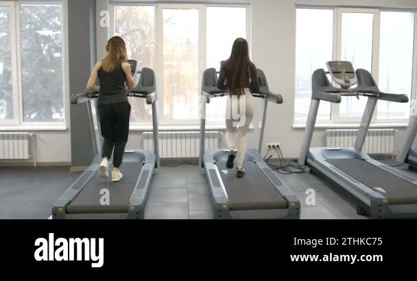 Rare view of a blonde woman in headphones and a girl with long dark ...