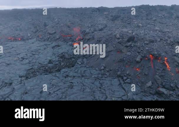 Aerial of steaming black lava rocks. Volcano eruption on Mauna Loa ...