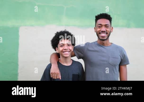 Two brothers hanging together smiling at camera. Young black African ...