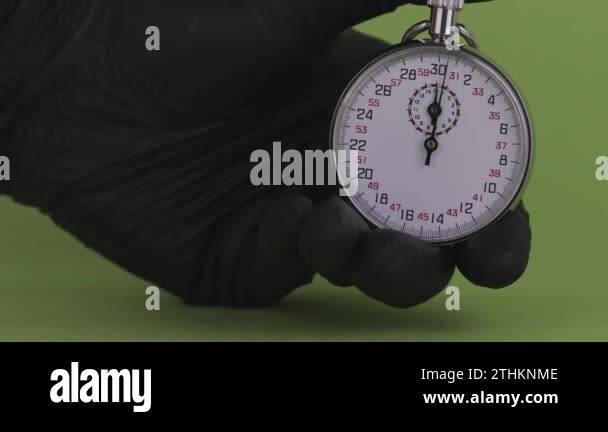 Mechanical stopwatch time in a human hand on a green screen Stock Video ...