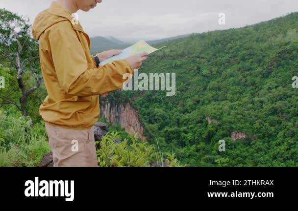 Compass and map in hands of traveler for checking and searching ...