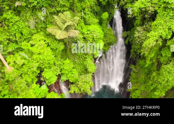 Aerial drone of Waterfall in the green forest. Tinago Falls in the jungle, island of Mindanao ...