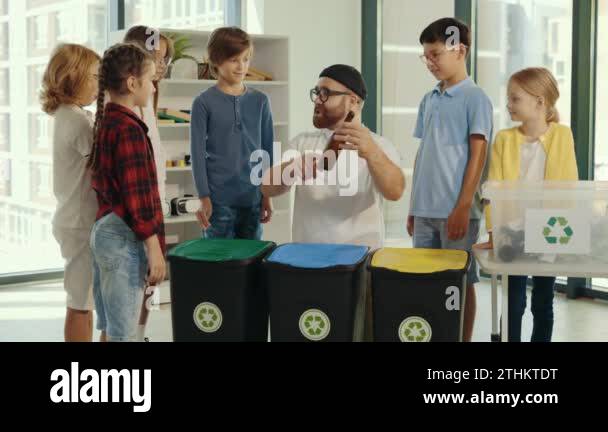 Male teacher teach how to sort the rubbish. Garbage sorting class, a ...