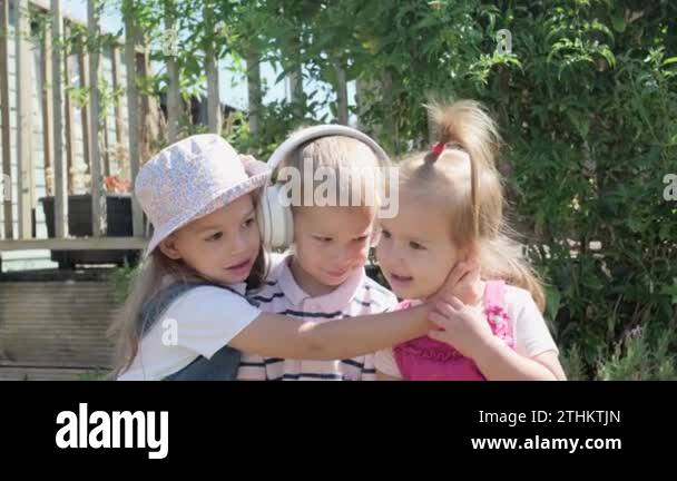 Portrait of Cute Little Three Children With Headphones Listening to ...
