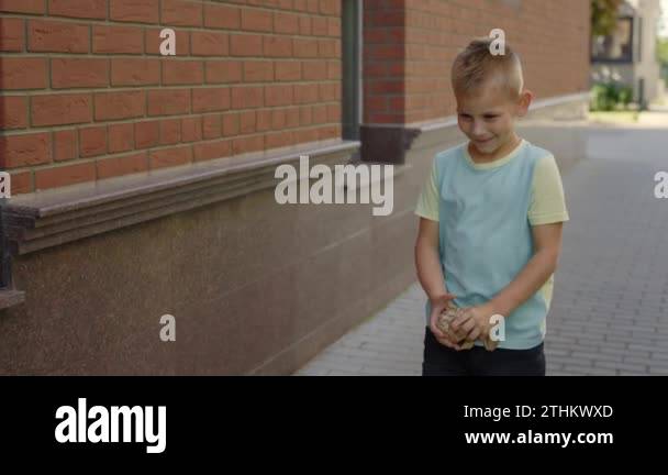 School boy is holding the paper and puts it to the correct bin for ...