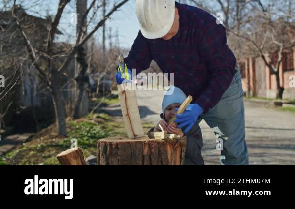 A family works together to build a safe and sturdy home. Grandfather ...