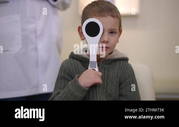 Portrait of cute charming Caucasian boy closing one eye with eye ...