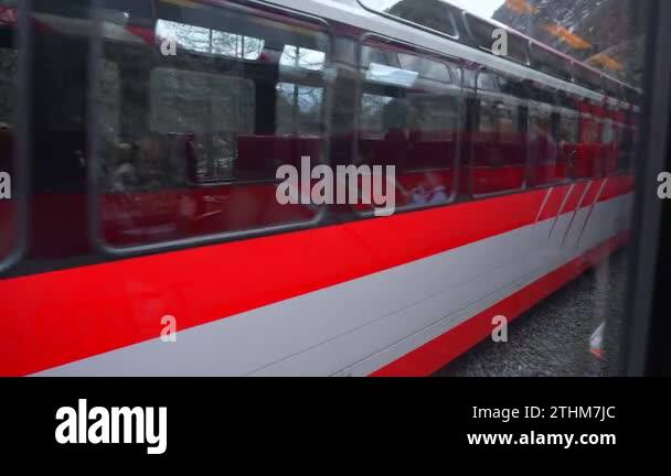 Riding a train on Zermatt Shuttle line in the Swiss Alps arriving to ...