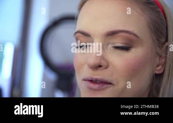 Close-up on the face of a woman wearing a red band. Demonstration of ...