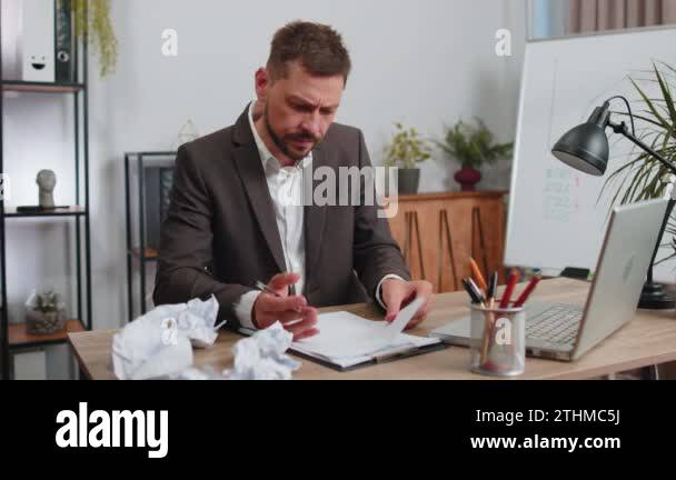 Angry furious man working at home office throwing crumpled paper ...