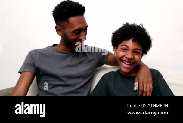 Two brothers relationship laughing and smiling together. Older and ...