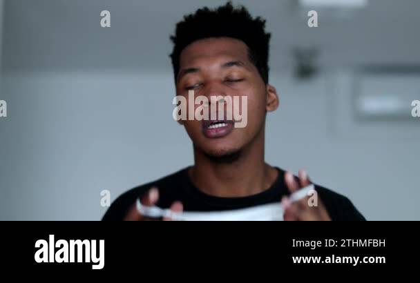 Black man removing surgical face mask feeling relief. African person ...