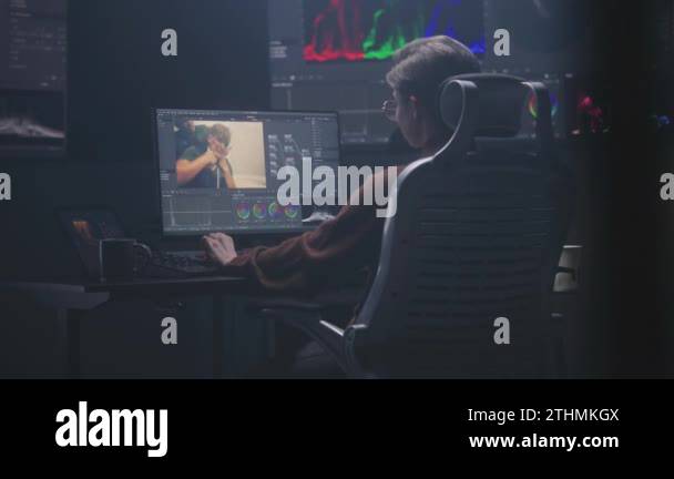 Female editor works in modern studio on computer using professional ...