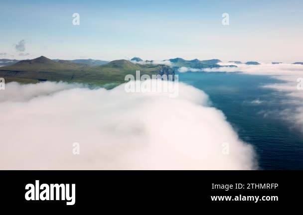 Aerial view of a Slave Cliff or Traelanipa hidden in the mist, Faroe ...