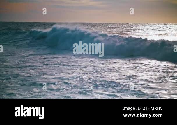 Foamy waves rolling sunrise shore slow motion. Beautiful seaside ...