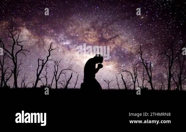 A lonely and desperate man praying for God's blessings. At night there ...