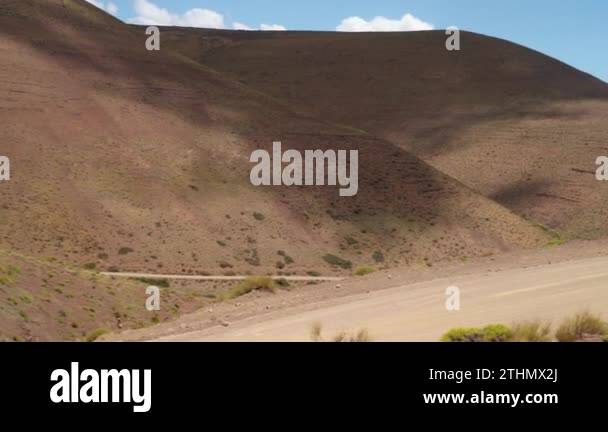 dusty gravel road of the iconic ruta 40 leading through the arid desert of Argentina Stock Video ...