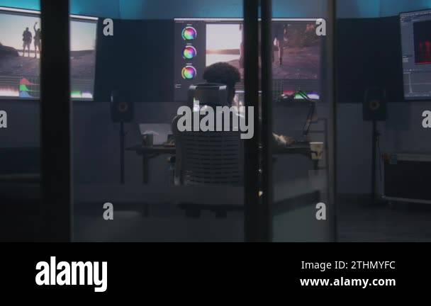 African American colorist does color grading in professional software ...