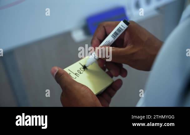 Handsome male detective writing on a sticker and sticking it on the map ...