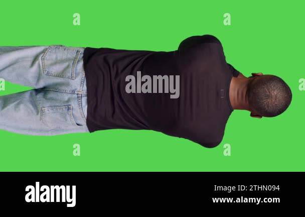 Vertical video: Back view of spiritual person praying to god in studio ...