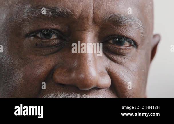 Macro extreme close up half part of face elderly middle-aged African ...