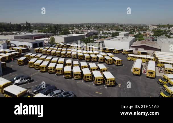 Dozens of yellow school buses parked in lot. School closed and bus ...