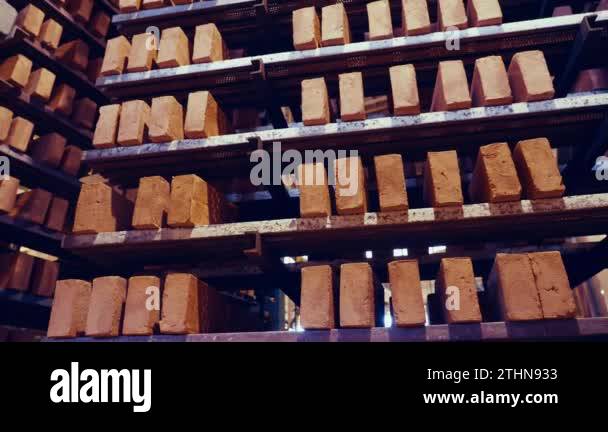 Rotating shelves of red oldschool bricks. Dried bricks from the kiln ...
