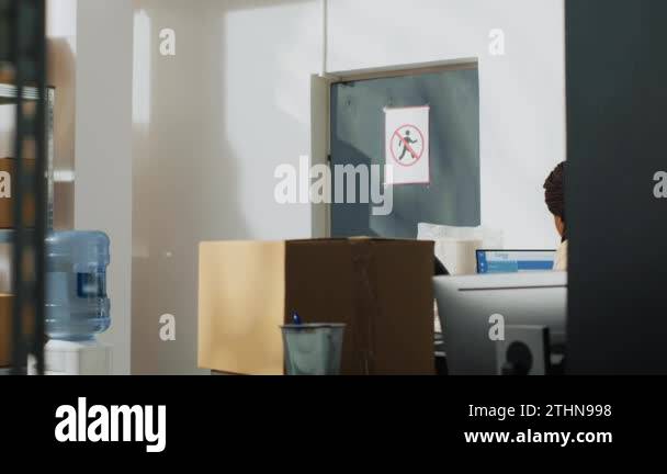 Storage room employees checking boxes of goods in warehouse, using ...