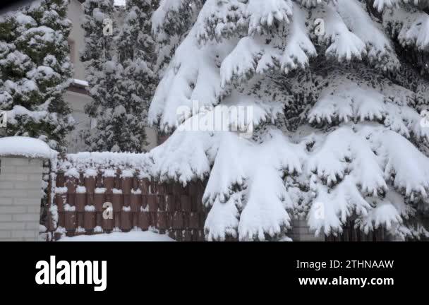 A snowdrift in front of the house. It snowed a lot on a winter day ...