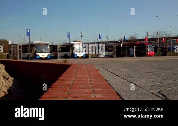 Buses wait at the stop for their ride with people for commuting. Bus ...