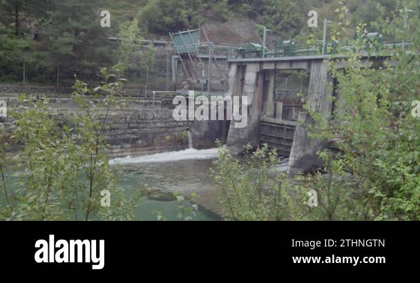 Hydroelectric power plant, river dam with flowing water at ...