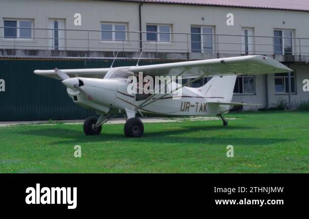 White small airplane starting engine ready taking off from airfield ...